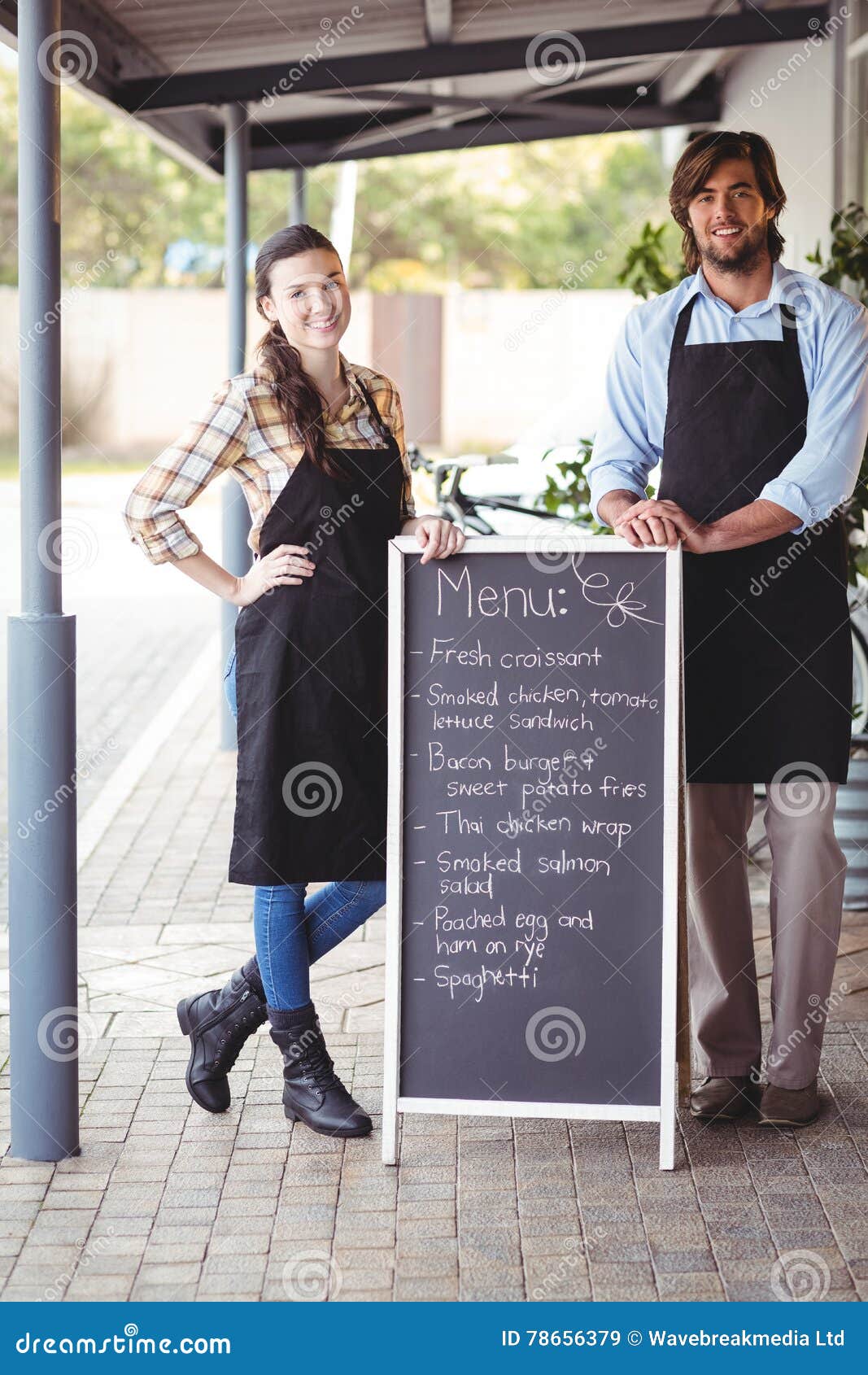 Waiter and Waitress Standing with Menu Board Outside the Cafe Stock ...