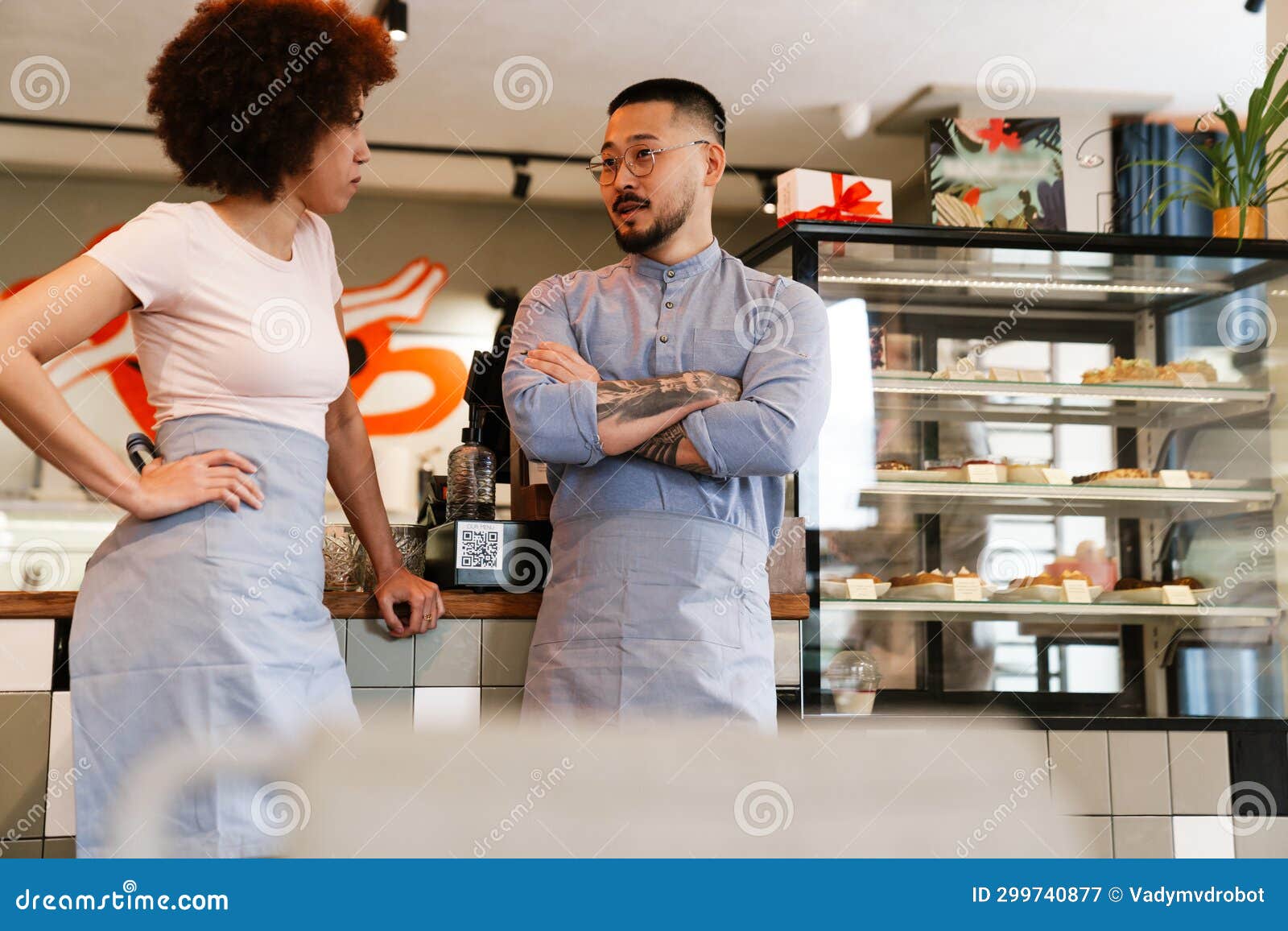 Waiter and Waitress Talking while Standing in Cafe Stock Image - Image ...