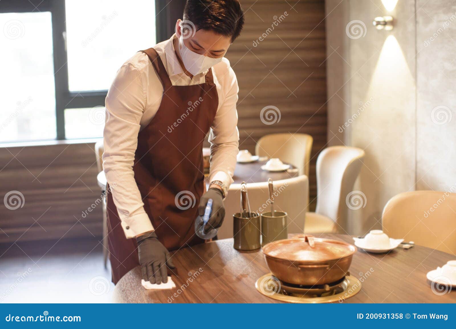 Waiter Wearing Protective Face Mask while Disinfecting in Restaurant ...