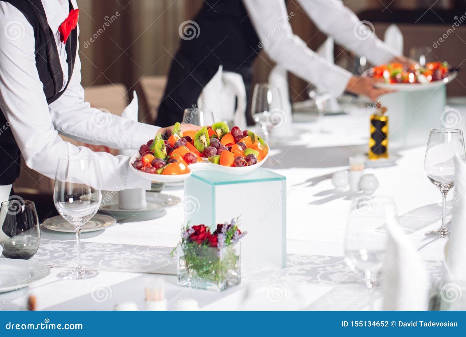 Waiters Serving Table in the Restaurant Preparing To Receive Guests ...