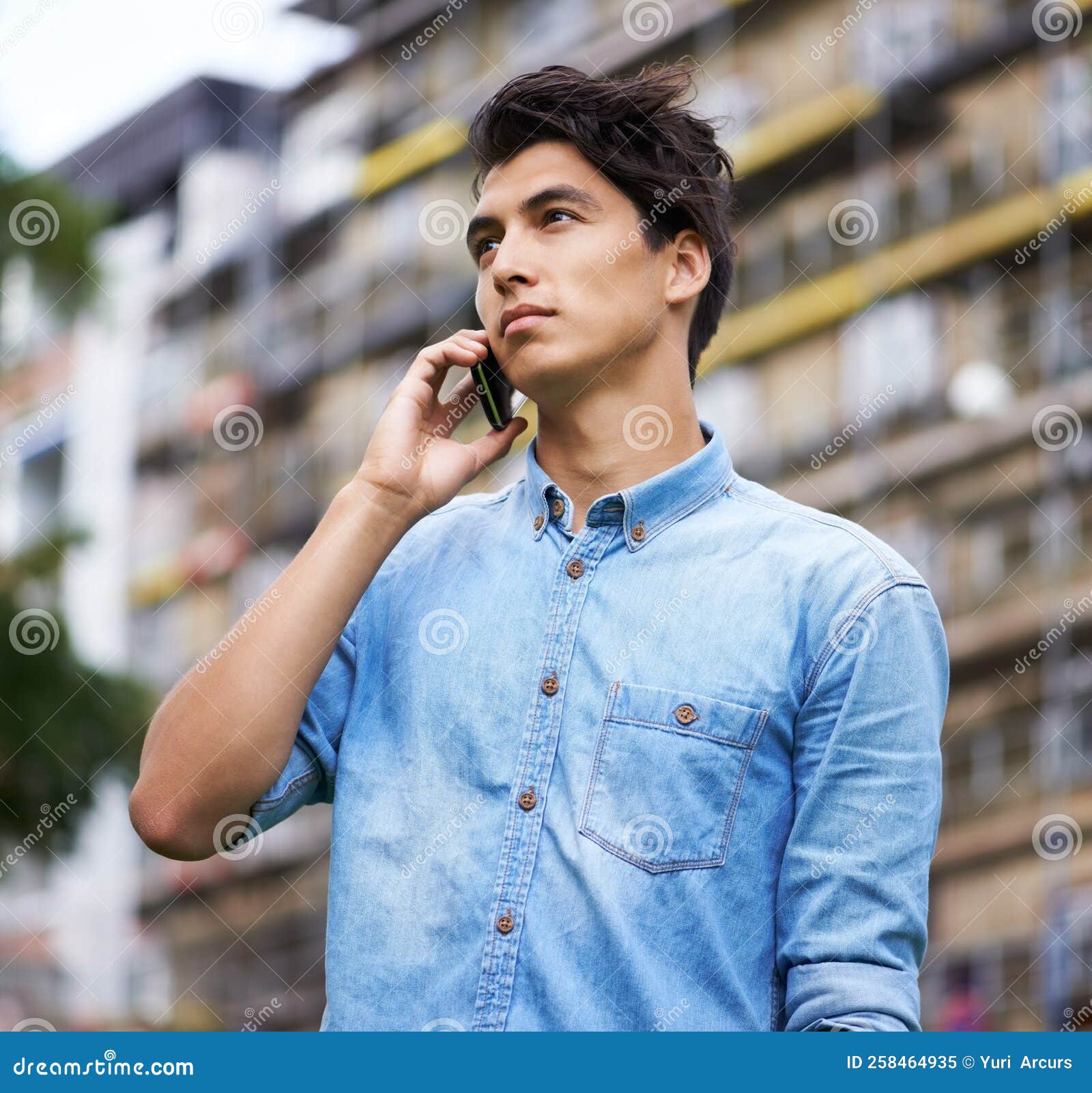 Waiting on an Answer. a Handsome Young Man Making a Call on His ...