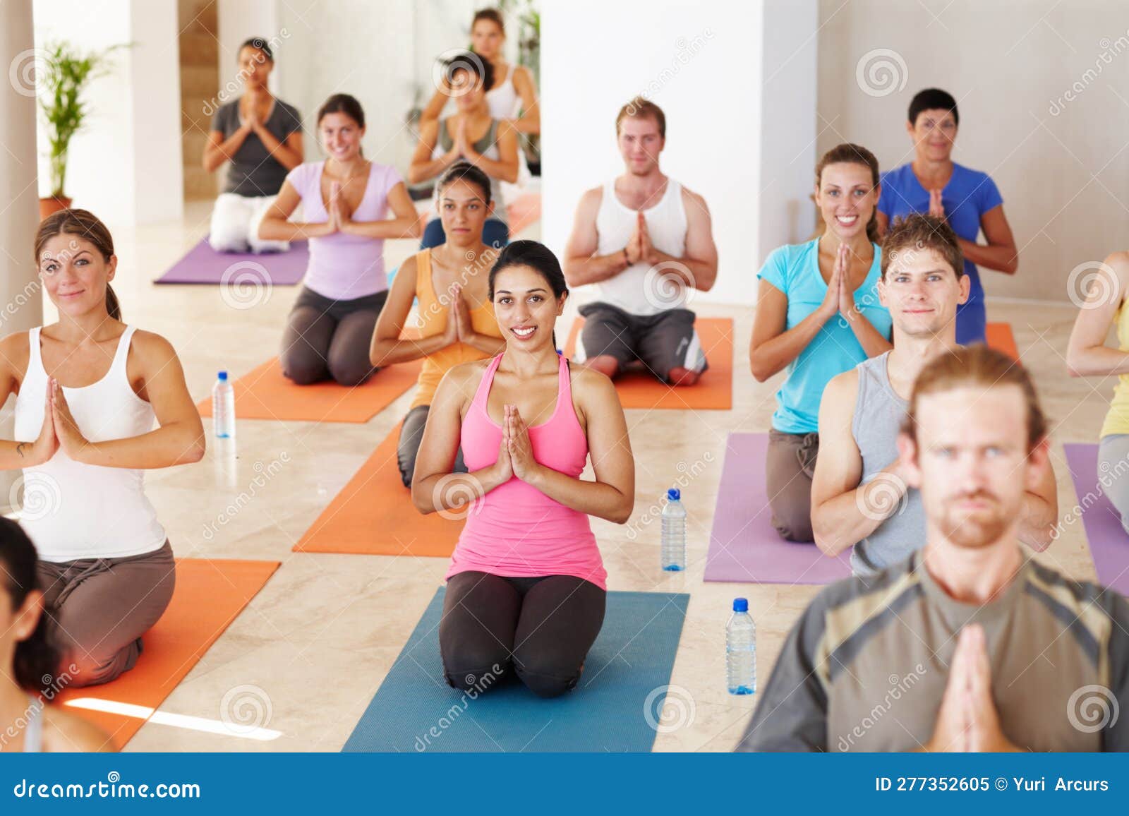Waiting for Instructions. a Group of People in Yoga Class Sitting with ...