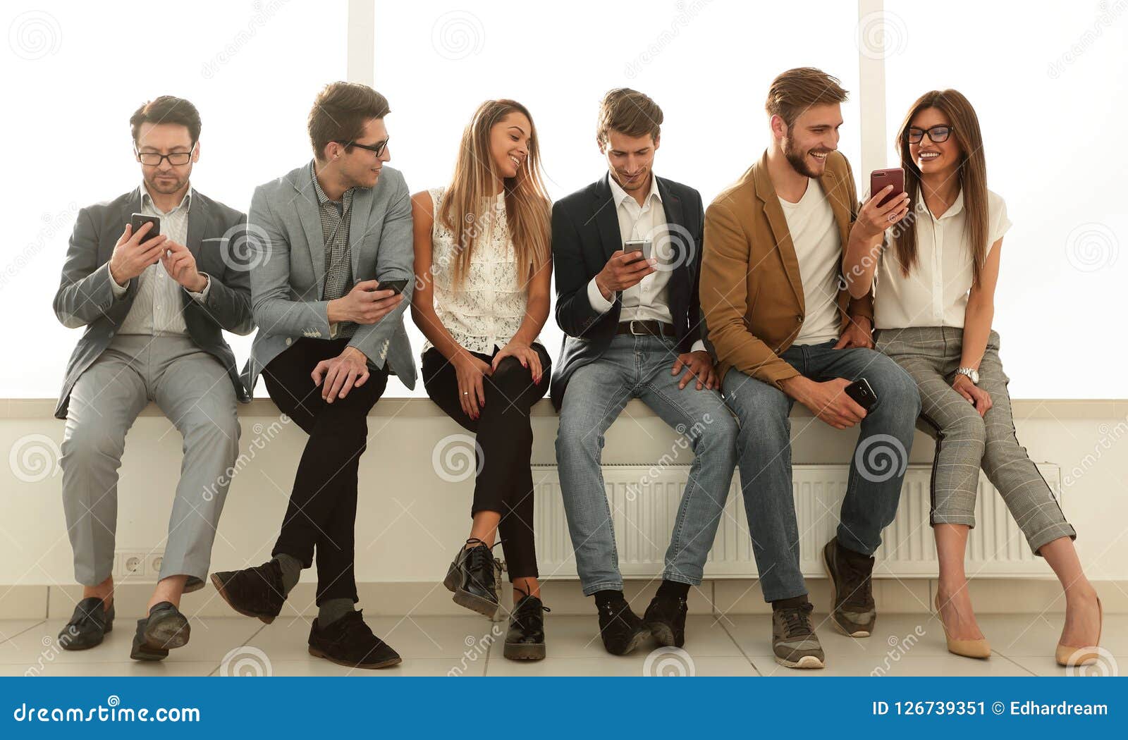 While Waiting for the Interview, a Group of Young People Use Gadgets ...