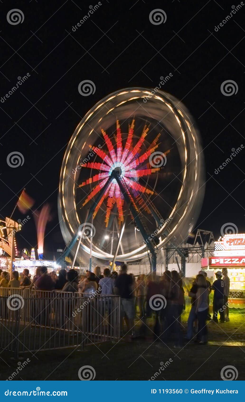 Waiting in Line with Ferris Wheel Motion Blur Stock Photo - Image of ...