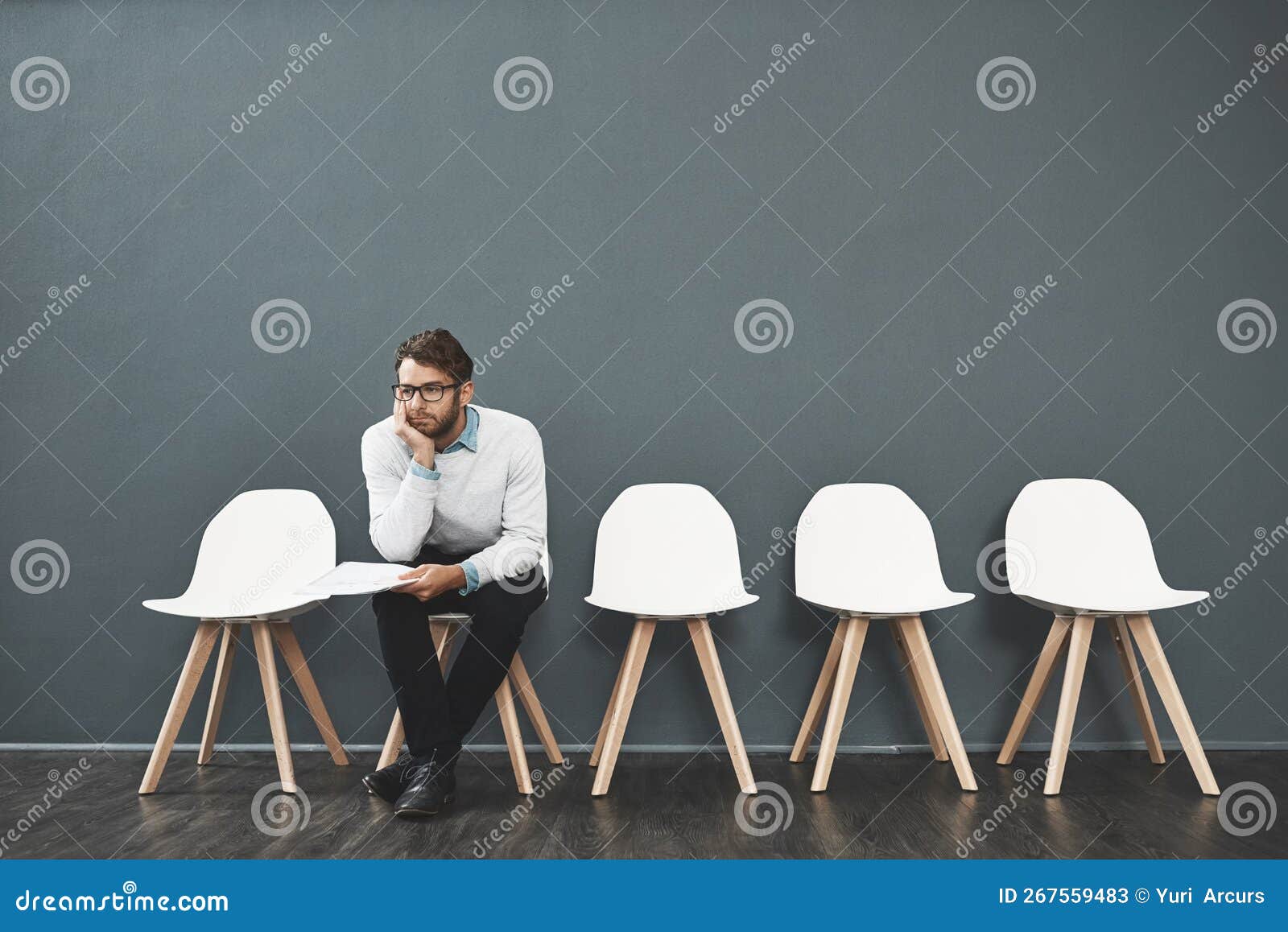 Waiting it Out. a Young Man Waiting in Line for a Job Interview. Stock ...