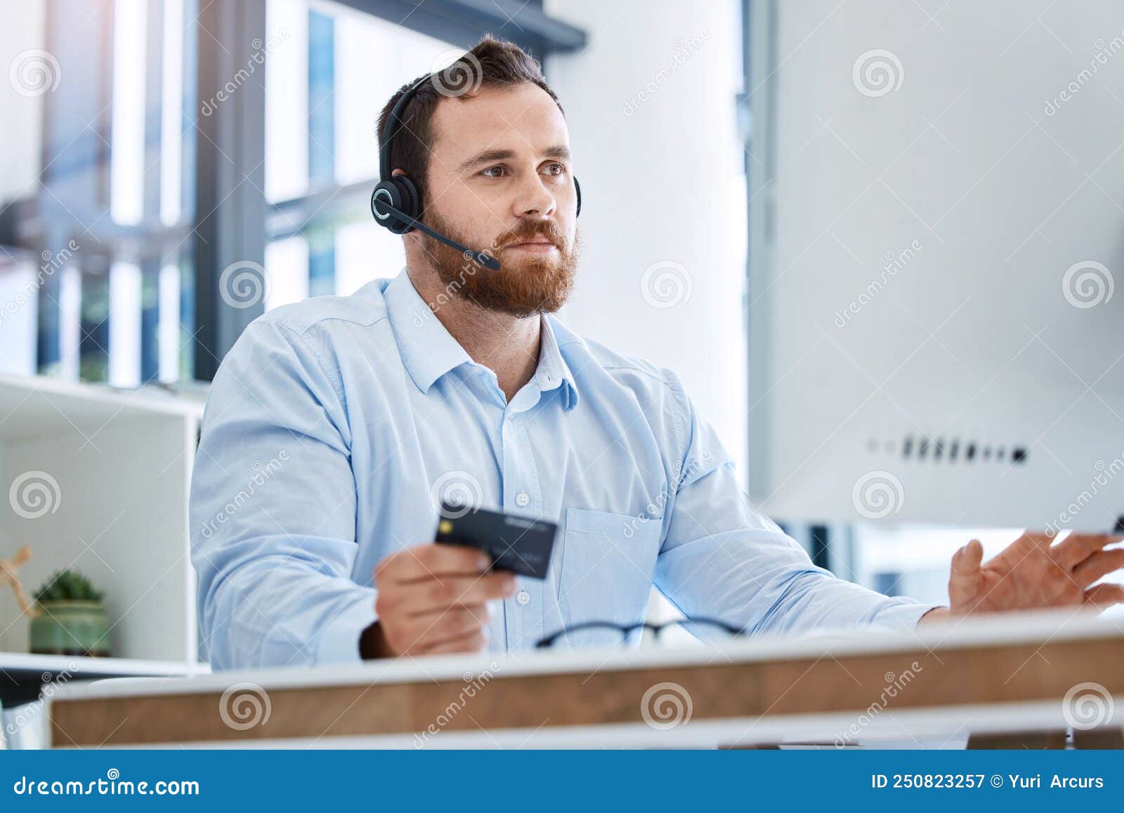 Waiting for Payment Confirmation. Shot of a Young Call Centre Agent ...