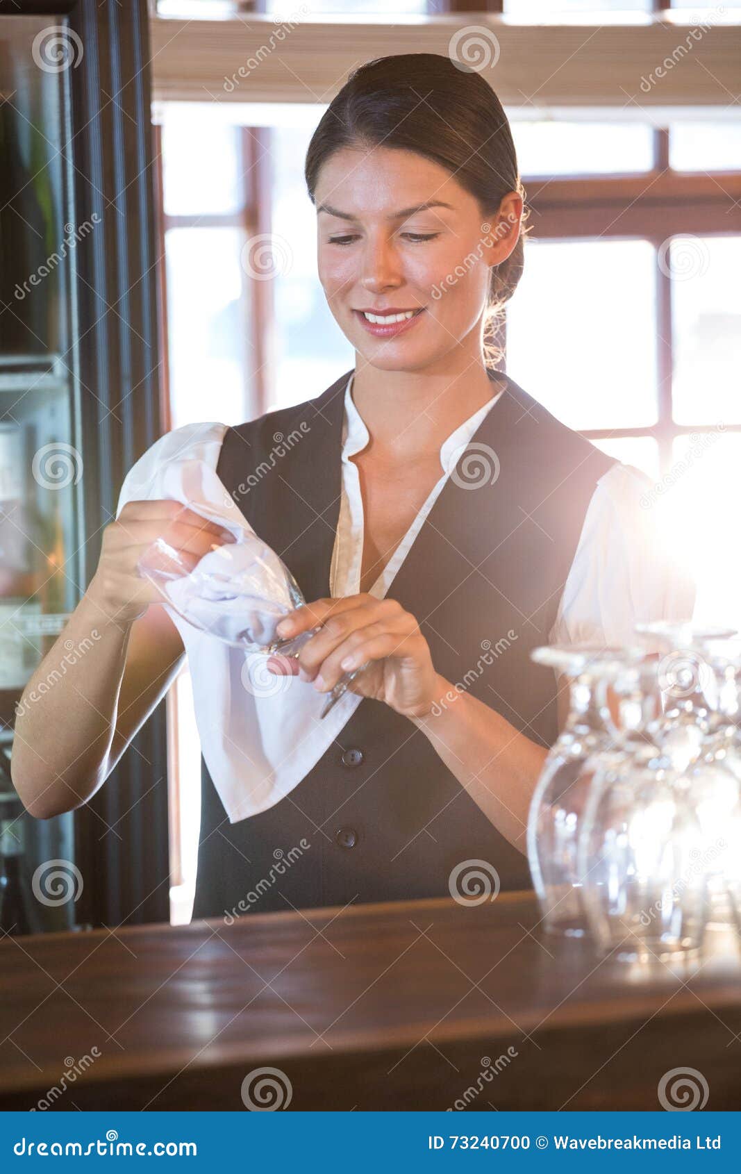 Waitress cleaning glasses stock photo. Image of cheerful - 73240700