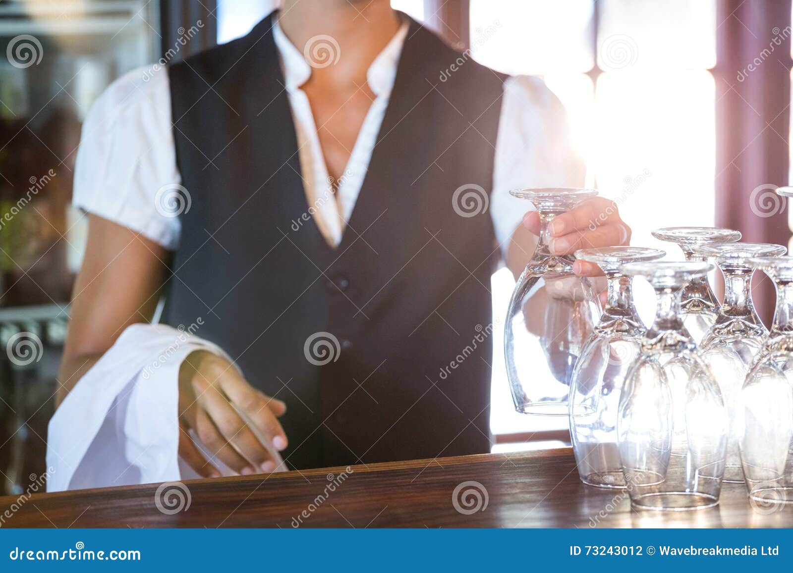 Waitress cleaning glasses stock photo. Image of preparing - 73243012
