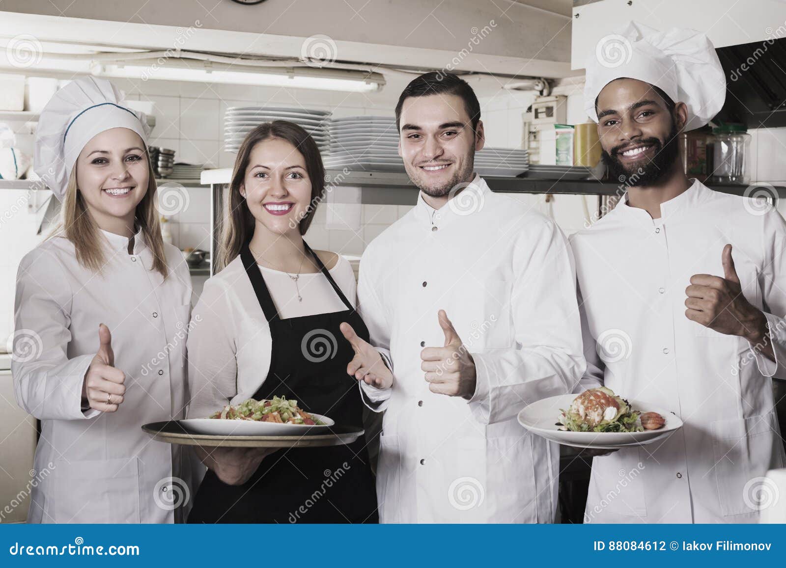 Waitress and Cooking Team in Restaurant Stock Photo - Image of ...