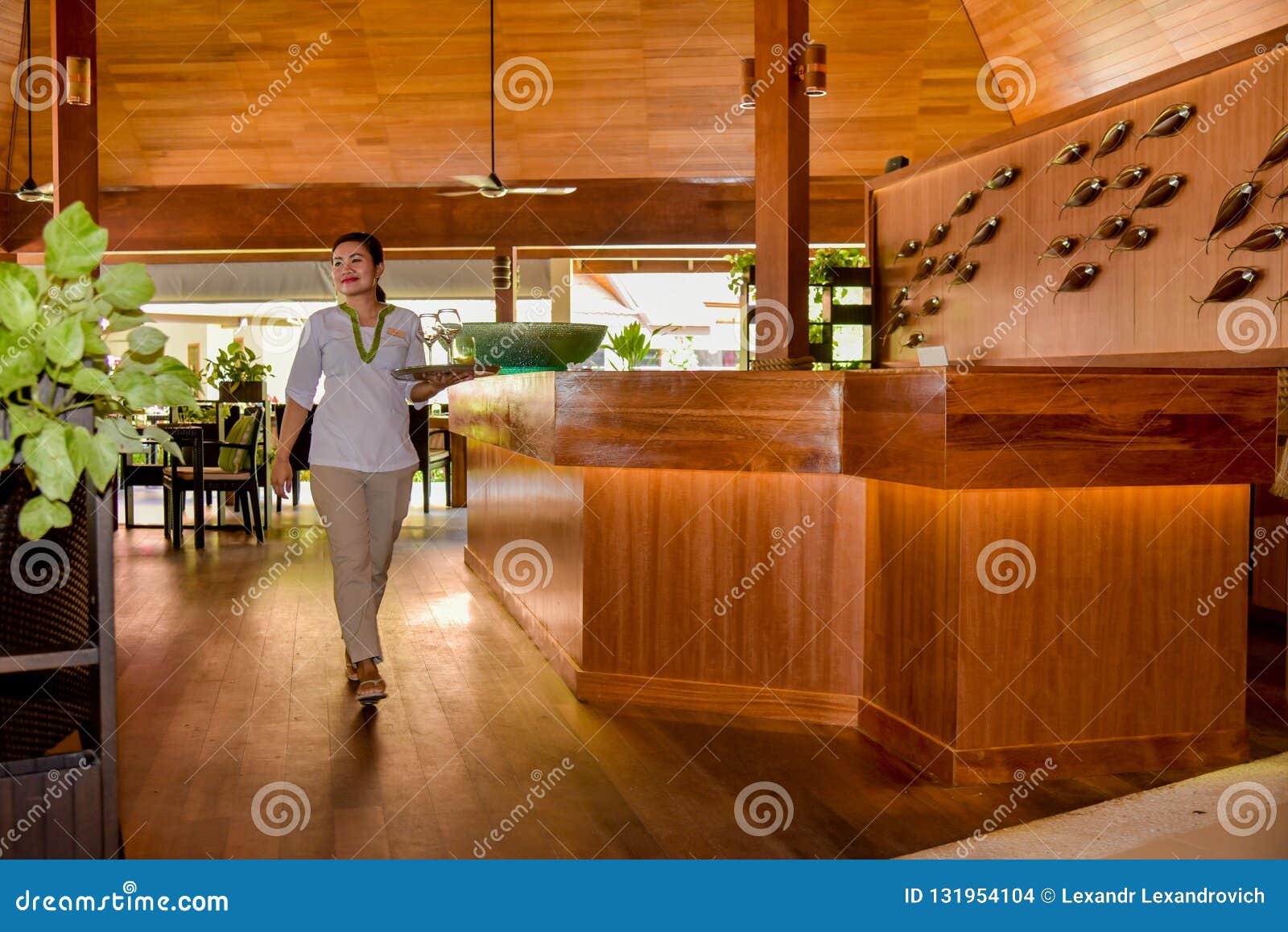 Waitress with Glasses on the Tray Walking in the Restaurant Editorial ...