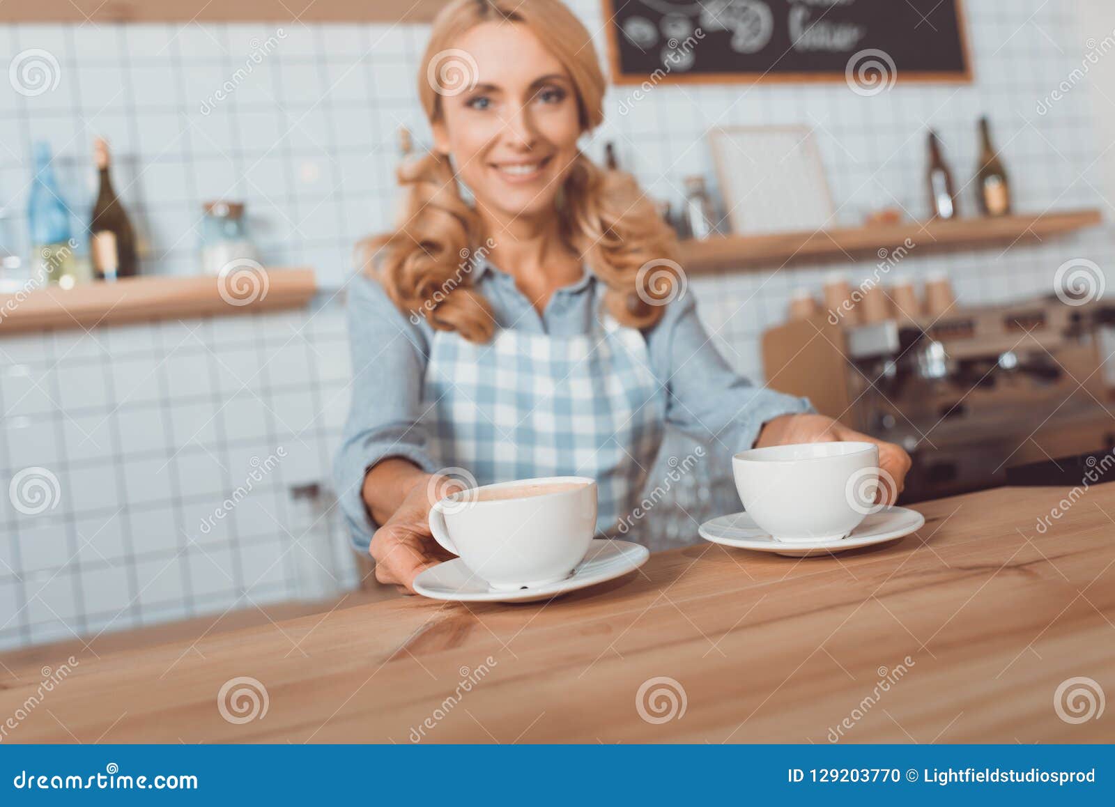 Close-up View of Smiling Waitress Holding Cups of Coffee Stock Photo ...
