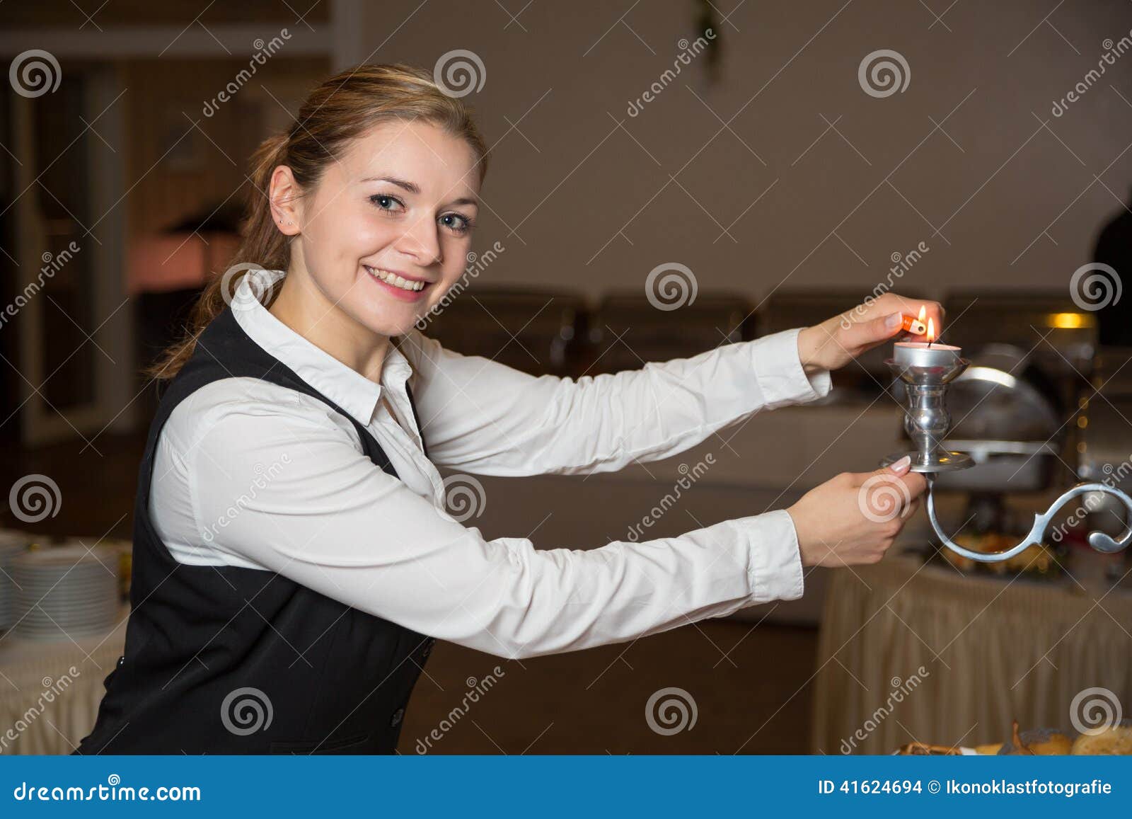 Waitress Lighting a Candle in a Restaurant Stock Photo - Image of ...