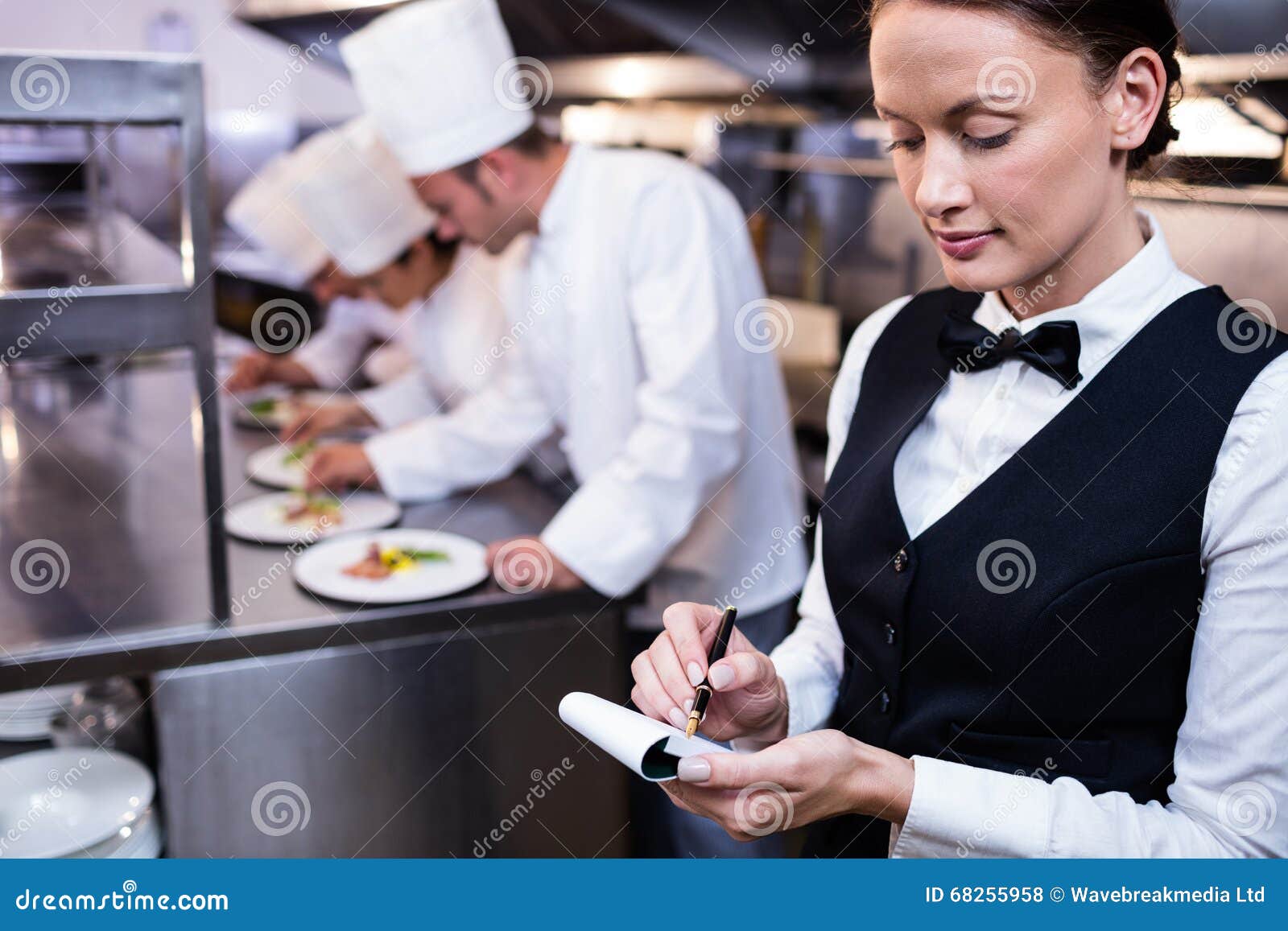Waitress with Note Pad in Commercial Kitchen Stock Photo - Image of ...