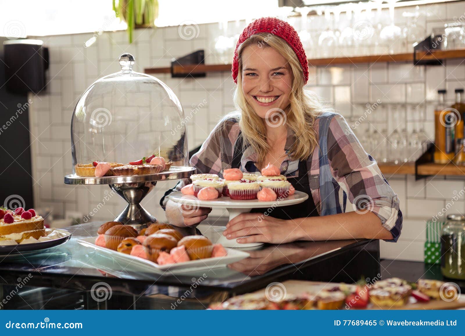 Waitress posing with cakes stock image. Image of cake - 77689465