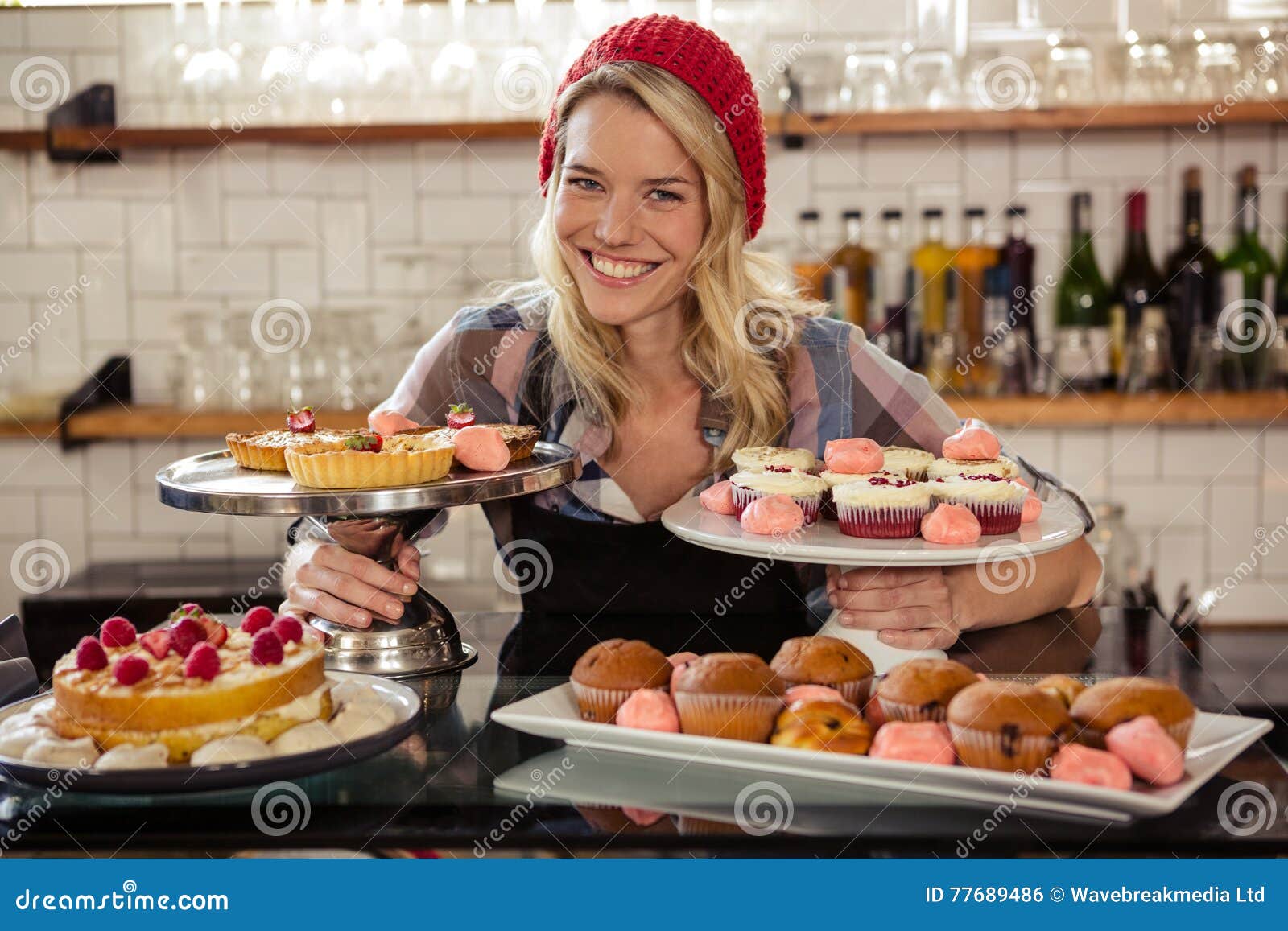 Waitress posing with cakes stock photo. Image of female - 77689486