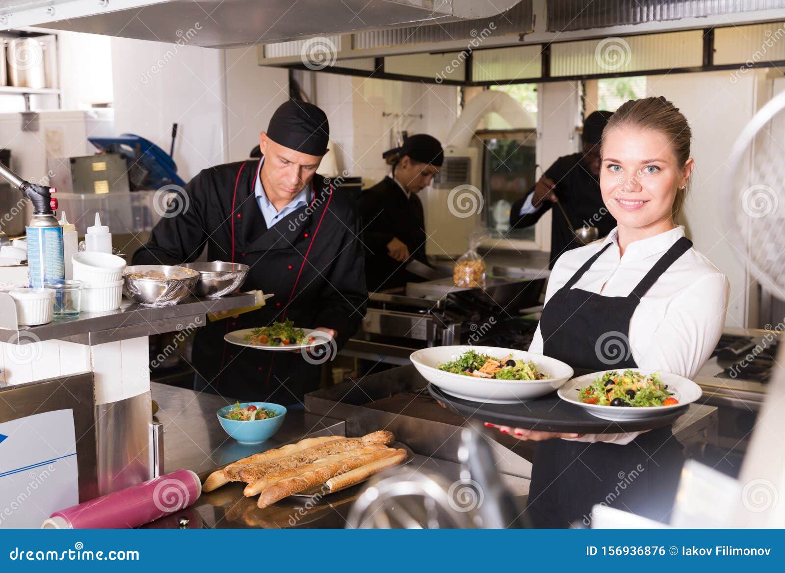 Waitress in Restaurant Kitchen with Ordered Meals Stock Photo - Image ...