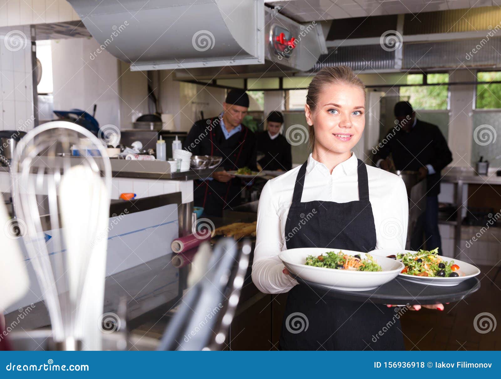 Waitress in Restaurant Kitchen with Ordered Meals Stock Photo - Image ...
