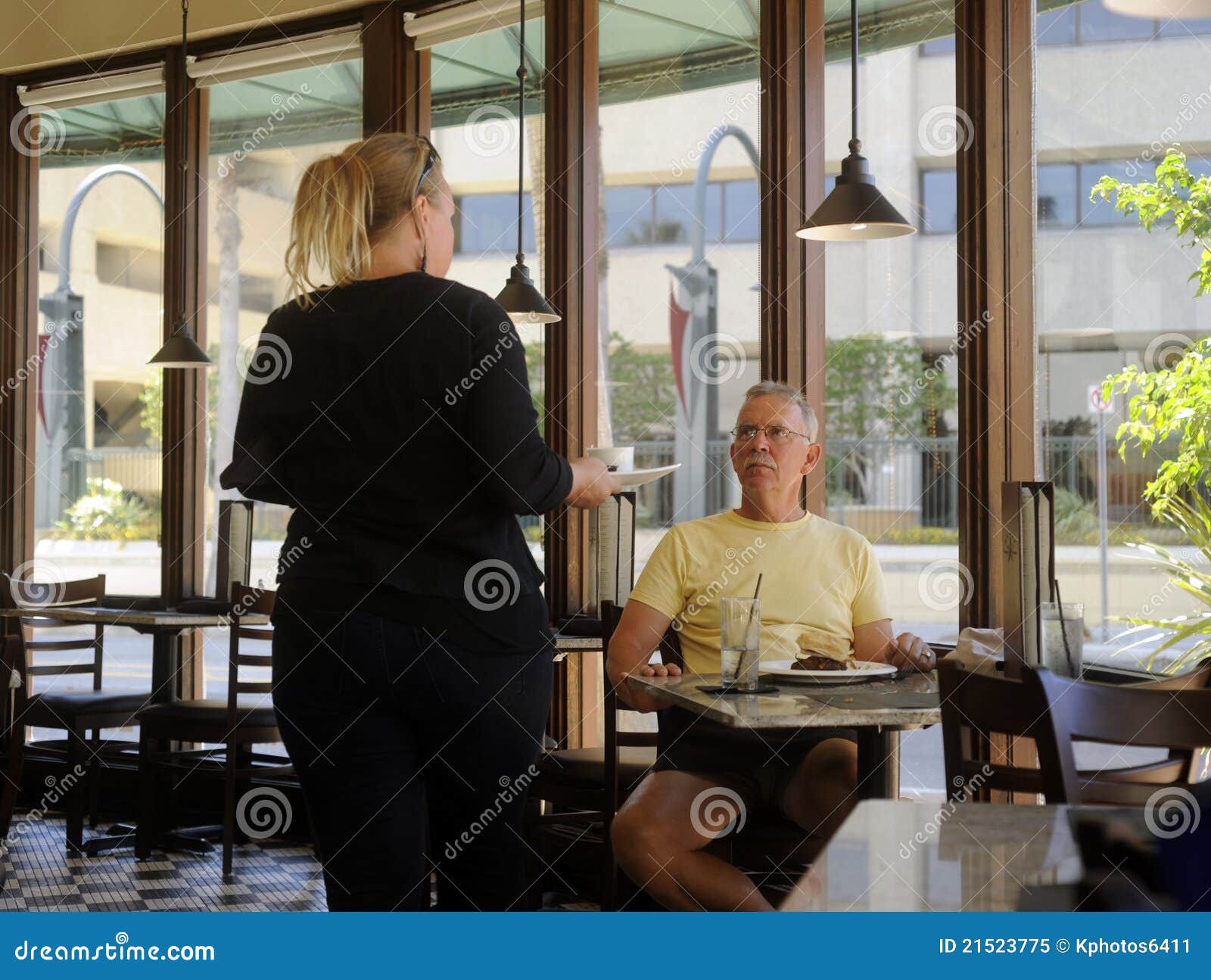 Waitress Serves Guest At Outdoor Cafe In Dutch Town Of Groningen In The ...