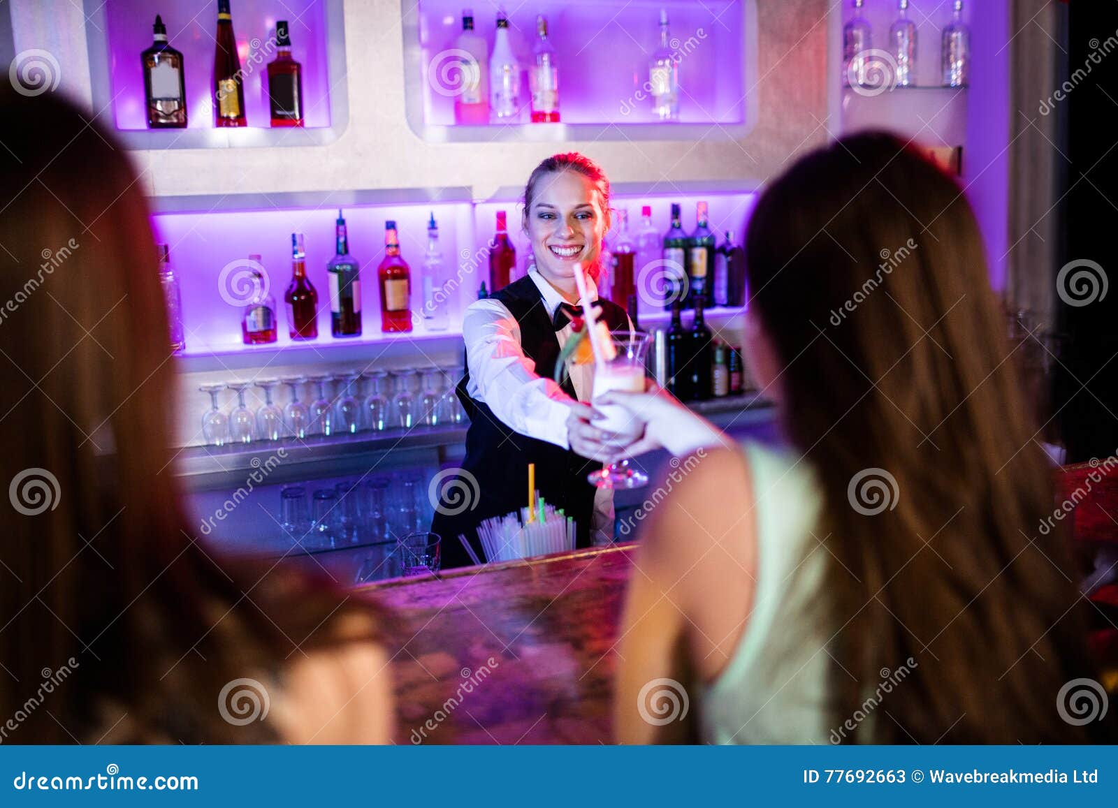 Waitress serving cocktail stock image. Image of adult - 77692663