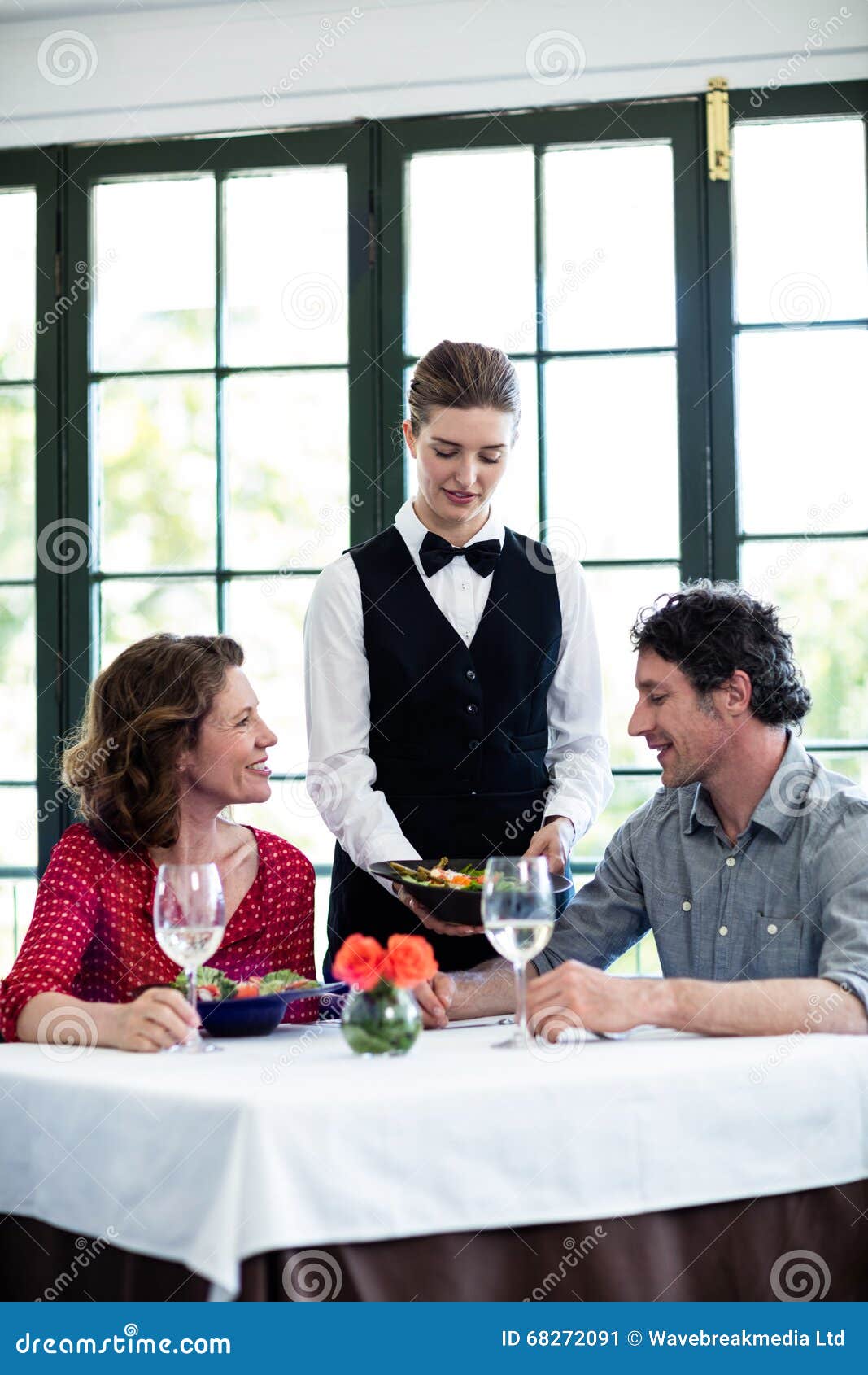 Waitress Serving Meal To a Couple Stock Image - Image of cheerful ...