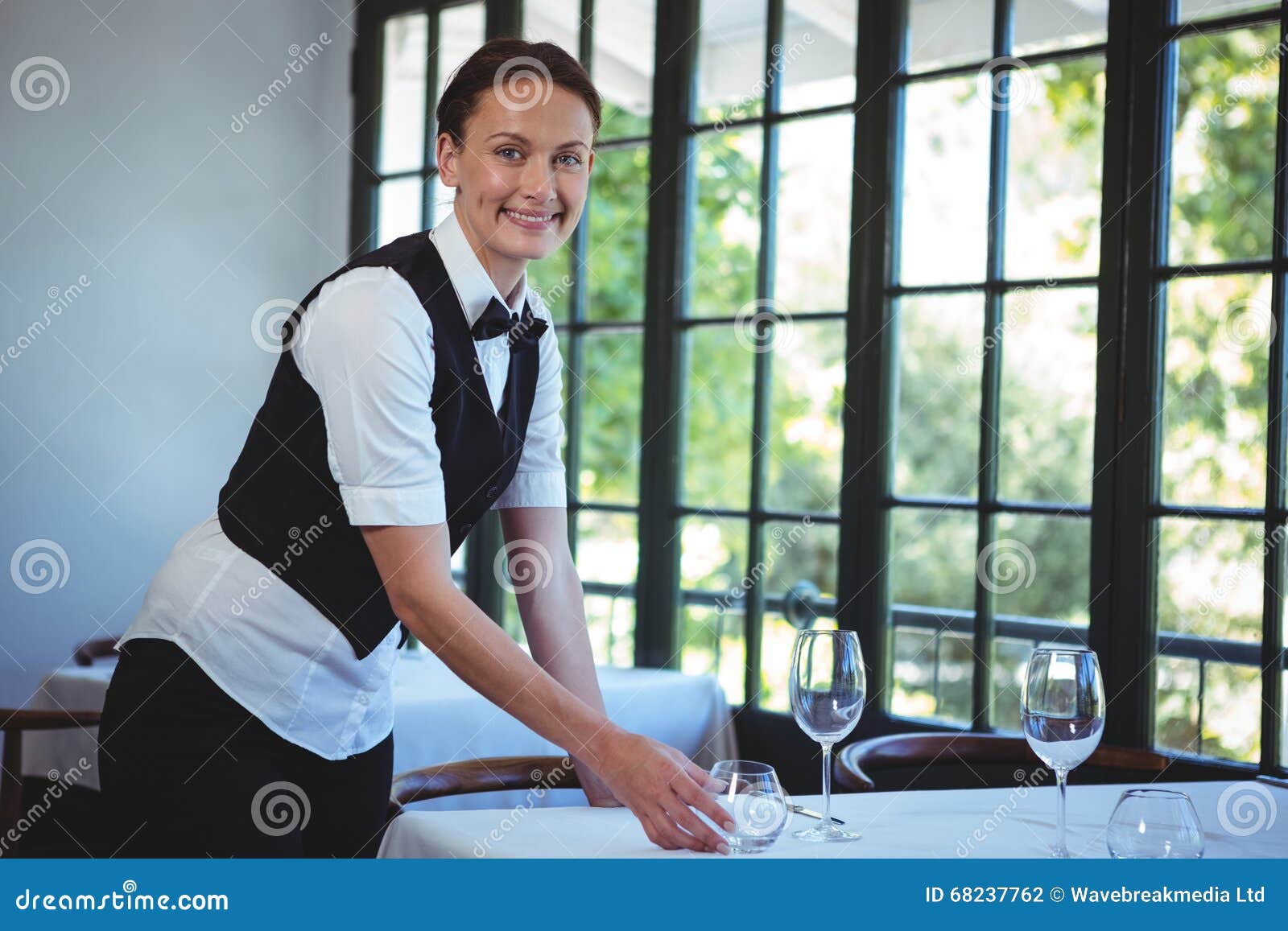 Waitress setting the table stock photo. Image of classy - 68237762