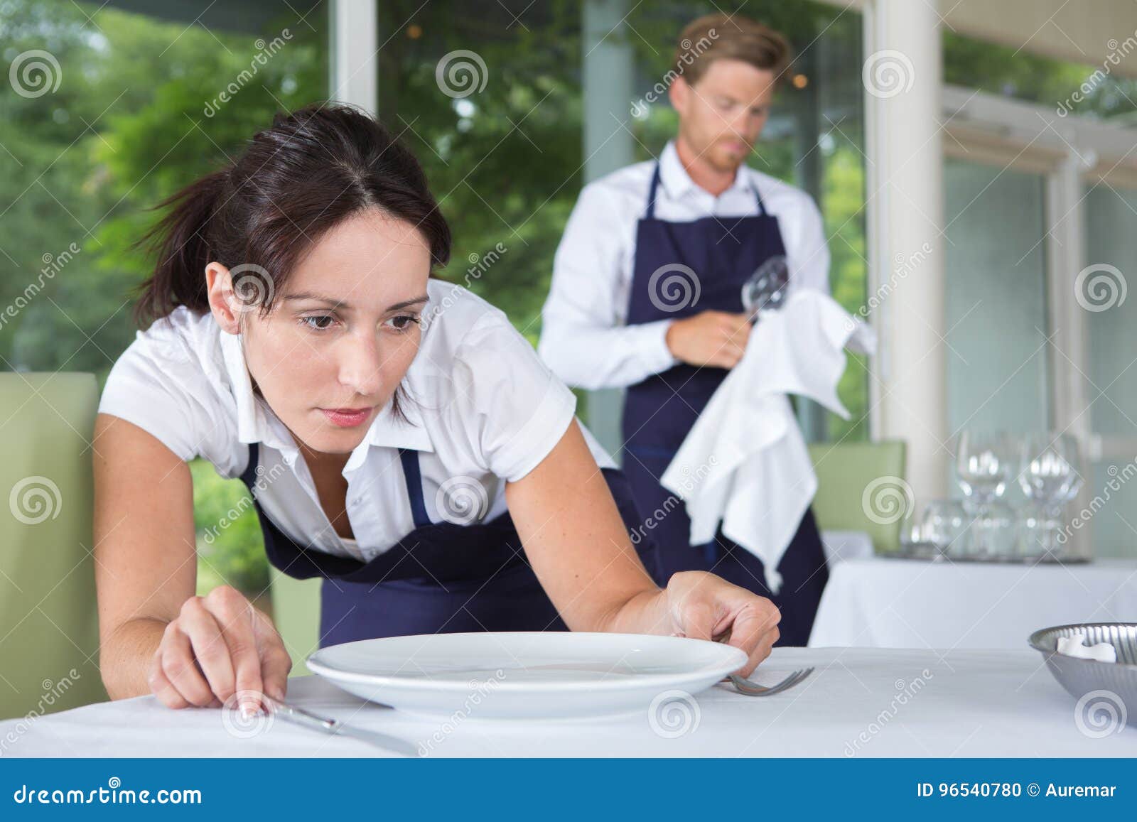 Waitress Setting Table in Restaurant Stock Photo - Image of uniform ...
