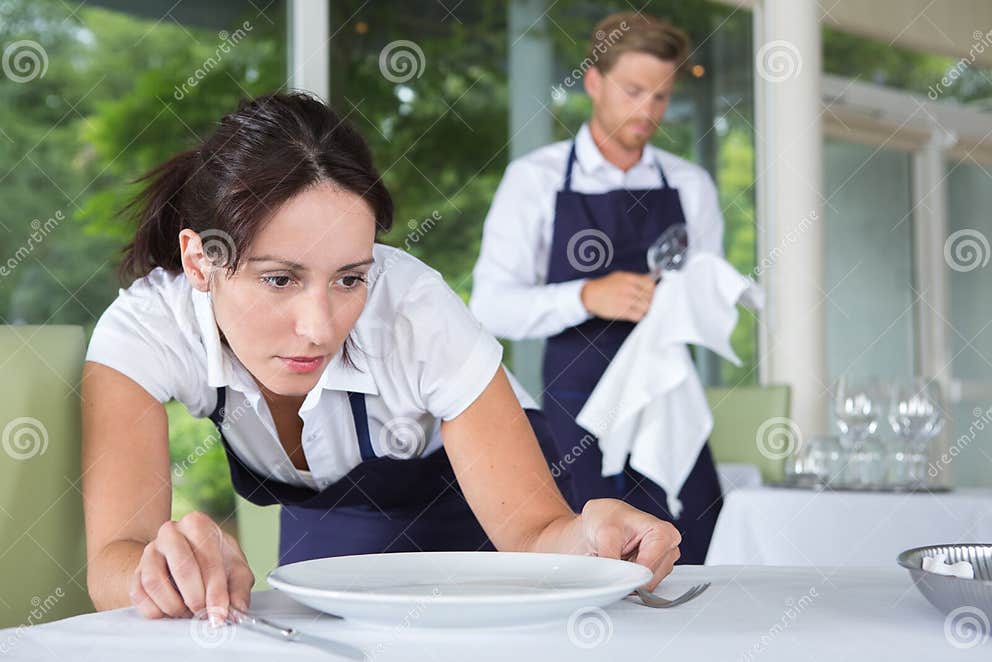 Waitress Setting Table in Restaurant Stock Photo - Image of uniform ...