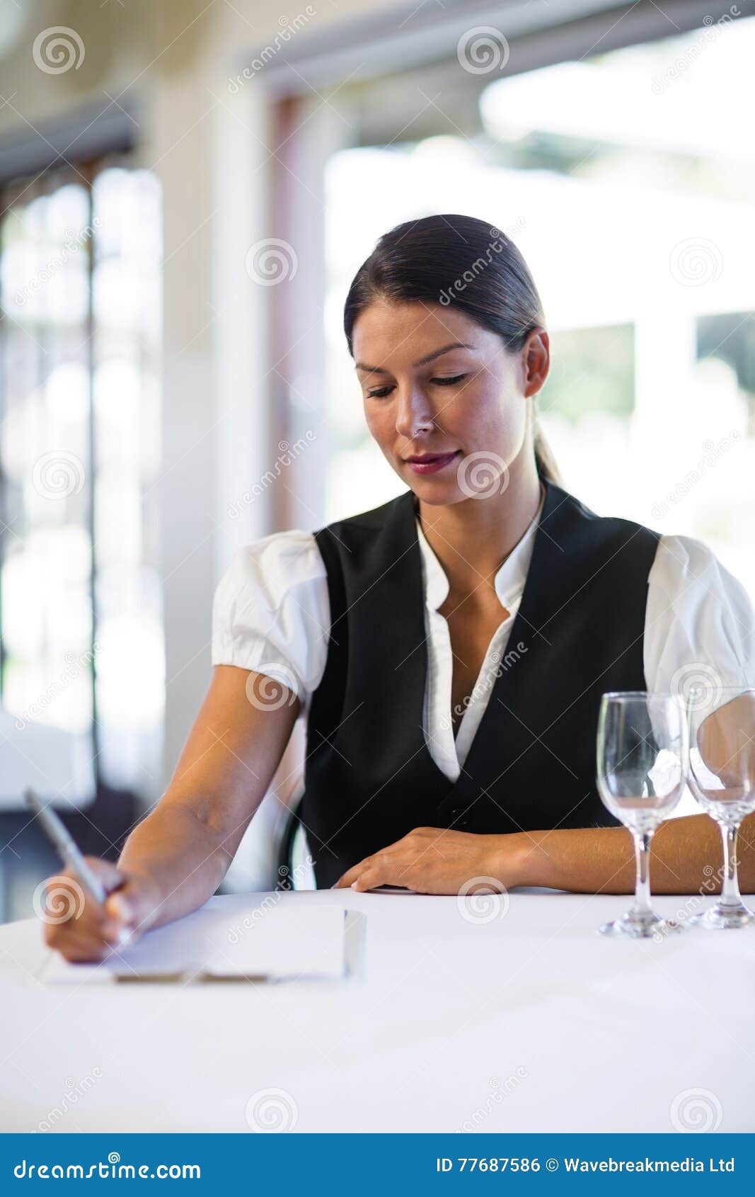 Waitress Sitting at the Table and Making Notes Stock Photo - Image of ...