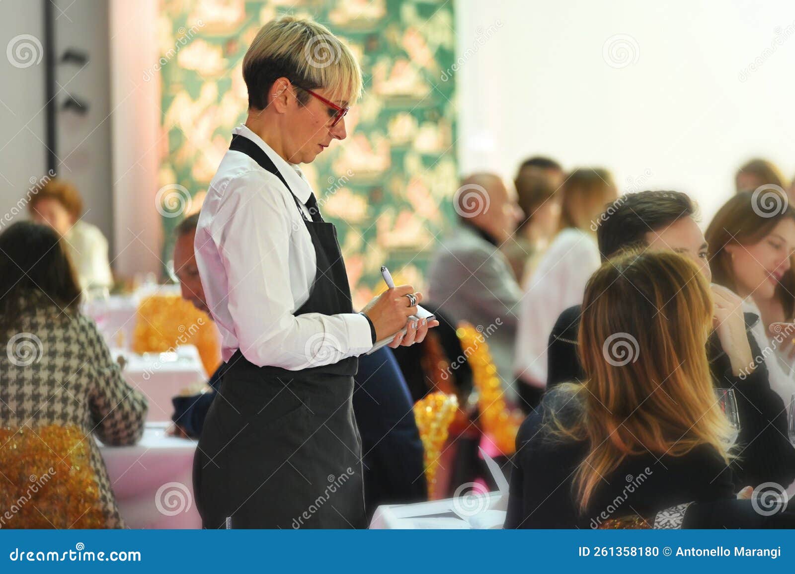 Waitress Takes Orders at the Diners` Table of Crowded Restaurant ...