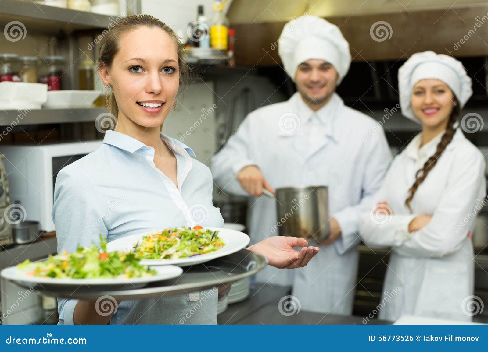 Waitress Taking Dish from Kitchen Stock Photo - Image of colleagues ...