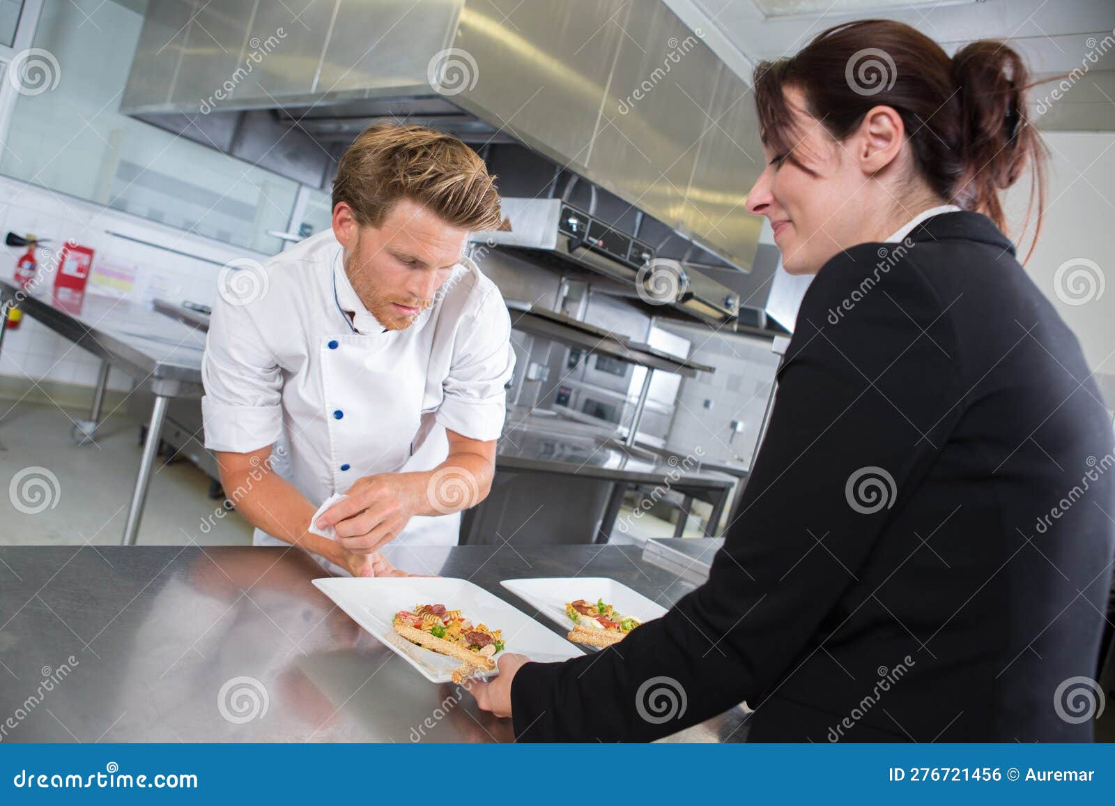 Waitress Taking Dishes from Kitchen Stock Photo - Image of female ...