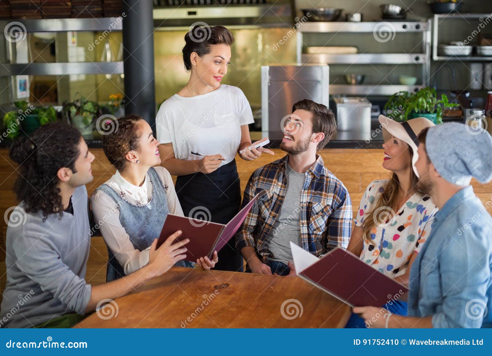 Waitress Talking To Customers in Restaurant Stock Photo - Image of cafe ...