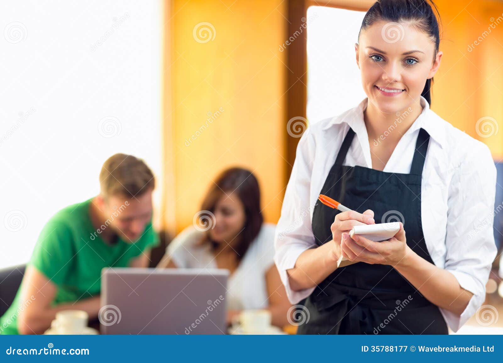 Waitress Writing an Order with Students Using Laptop at Coffee Shop ...