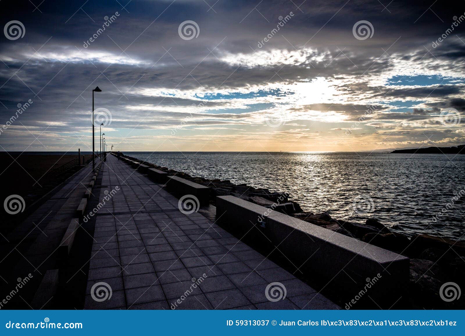 Walk along the breakwater stock image. Image of spain - 59313037