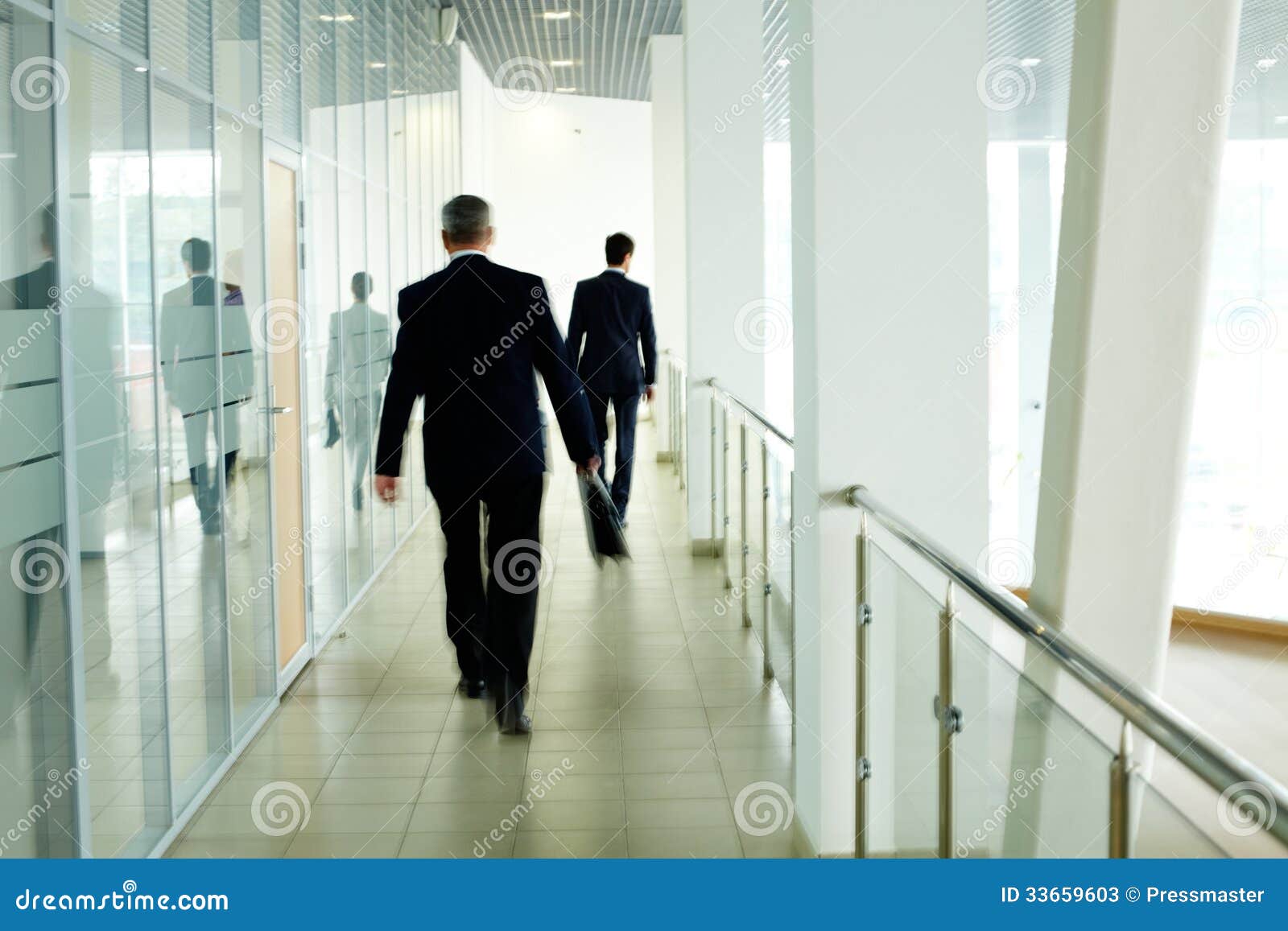Walking along corridor stock image. Image of corporation - 33659603