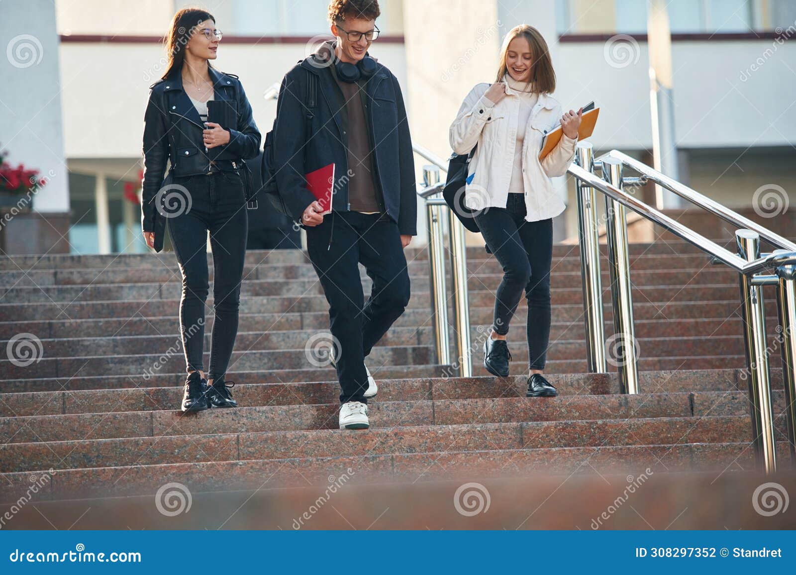 Walking Down the Stairs. Three Young Students are Outside the ...