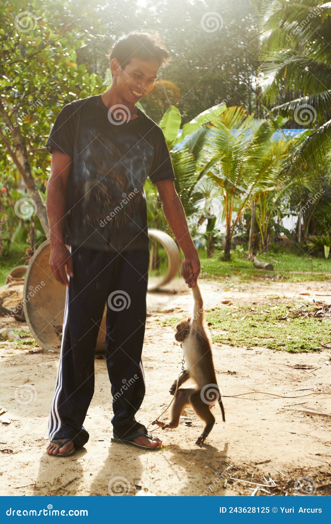 Walking Hand in Hand. a Thai Trainer Holding the Hand of His Monkey ...