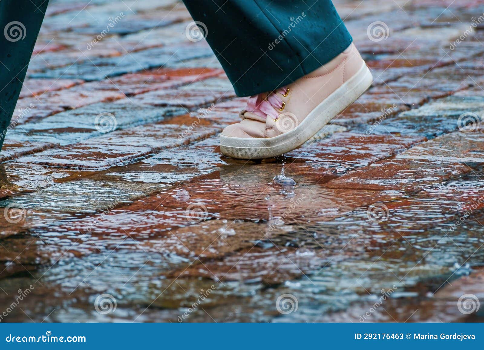 Walking through a Puddle in the Rain. a Passerby S Foot on the Paving ...