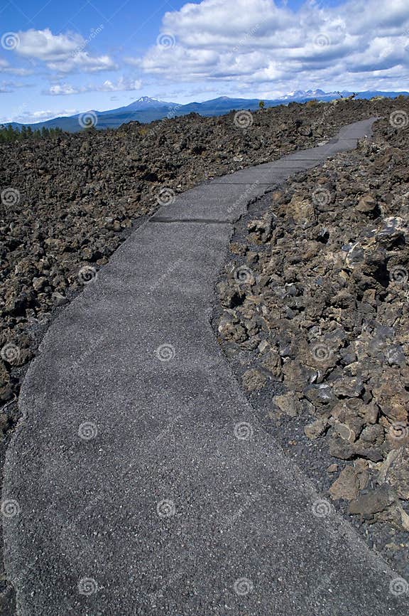 Walkway Going through Lava Rock Stock Image - Image of clouds, mountain ...
