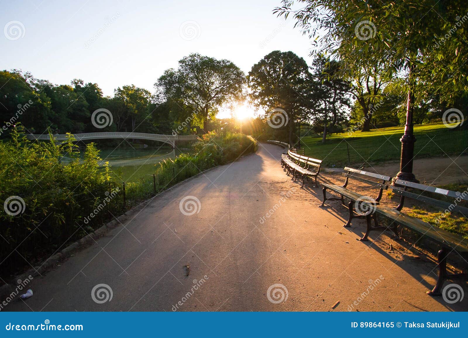 Walkway and Park Bench Next To Bow Bridge with Sunrise Stock Image ...