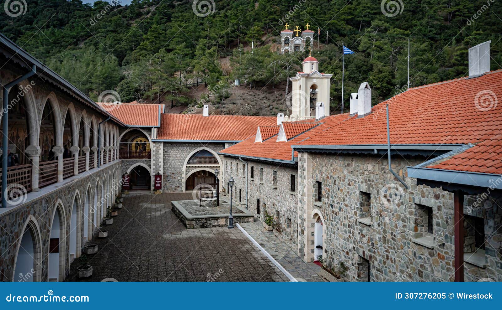 A Walkway between Two Buildings with a Building Below and One on a Hill ...