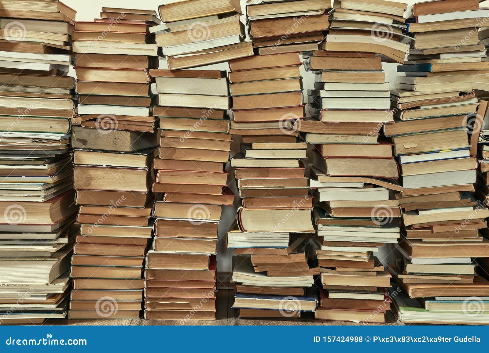 Wall of books piled up stock photo. Image of clutter - 157424988