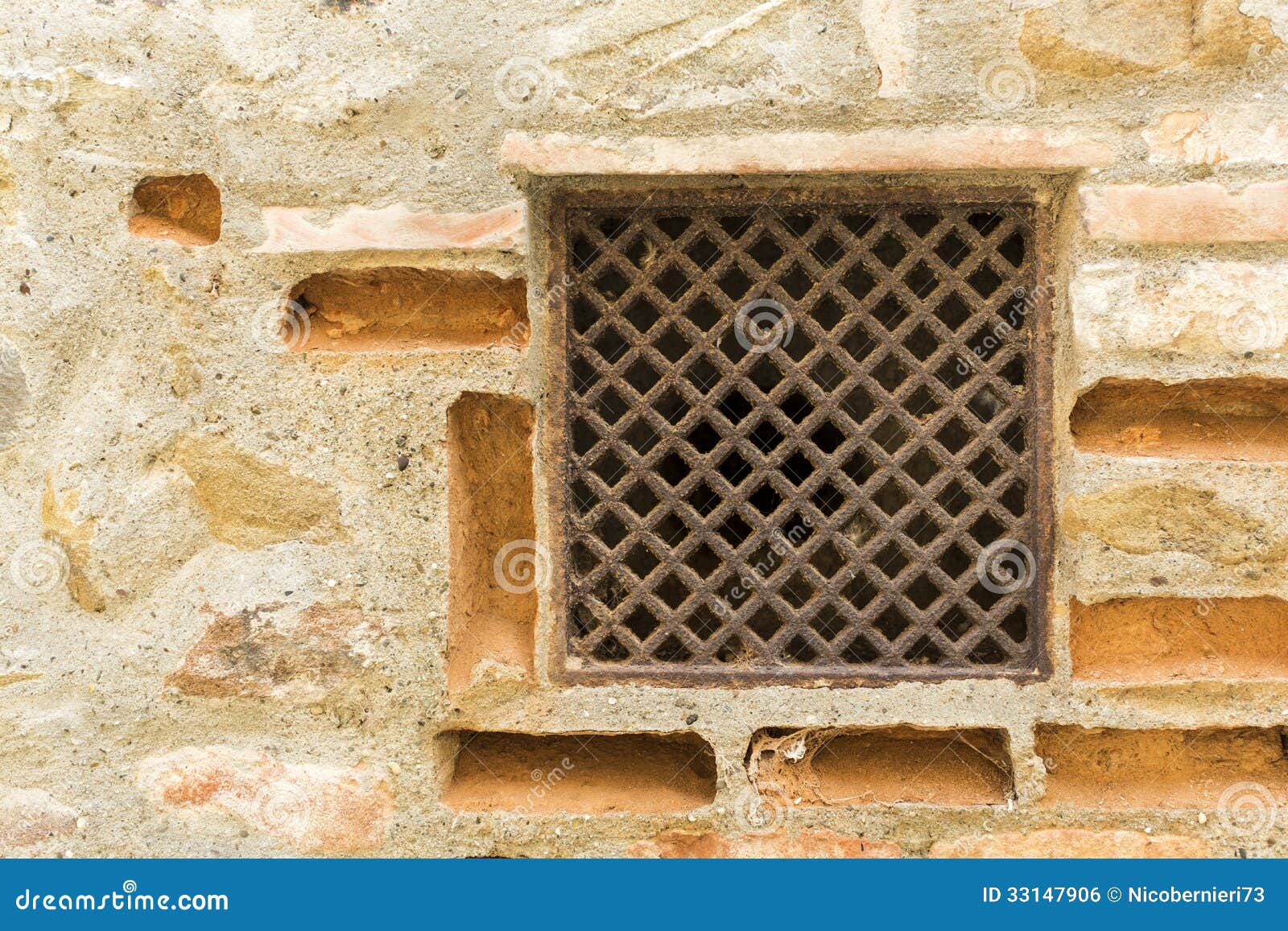 Wall of bricks with grate stock photo. Image of cement - 33147906
