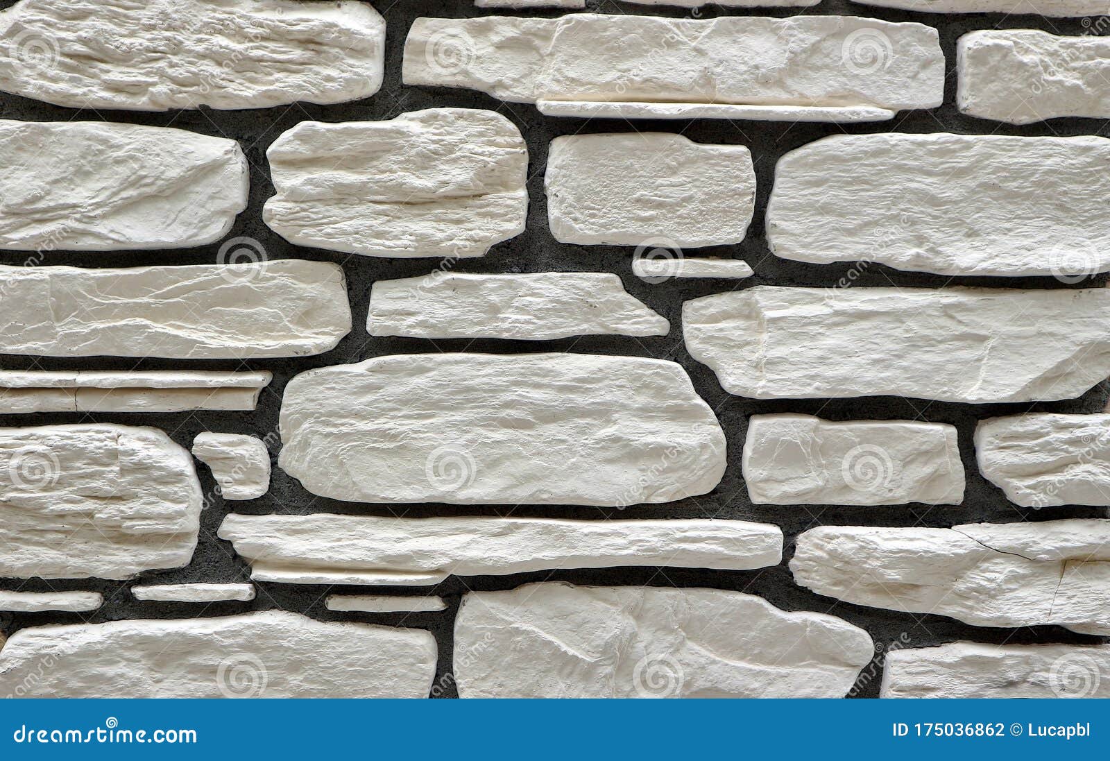 Wall Cladding Made of Large Irregular White Stones on Black Concrete ...