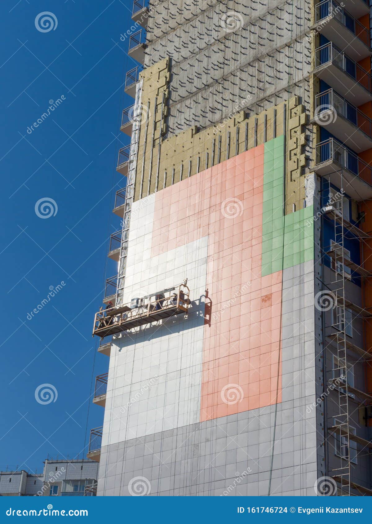 The Wall Cladding Process of a New Residential Building. Weights a ...