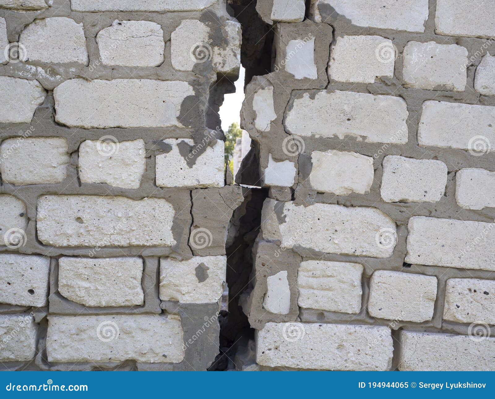 A Wall of Concrete Blocks with a Huge Crack Stock Image - Image of huge ...