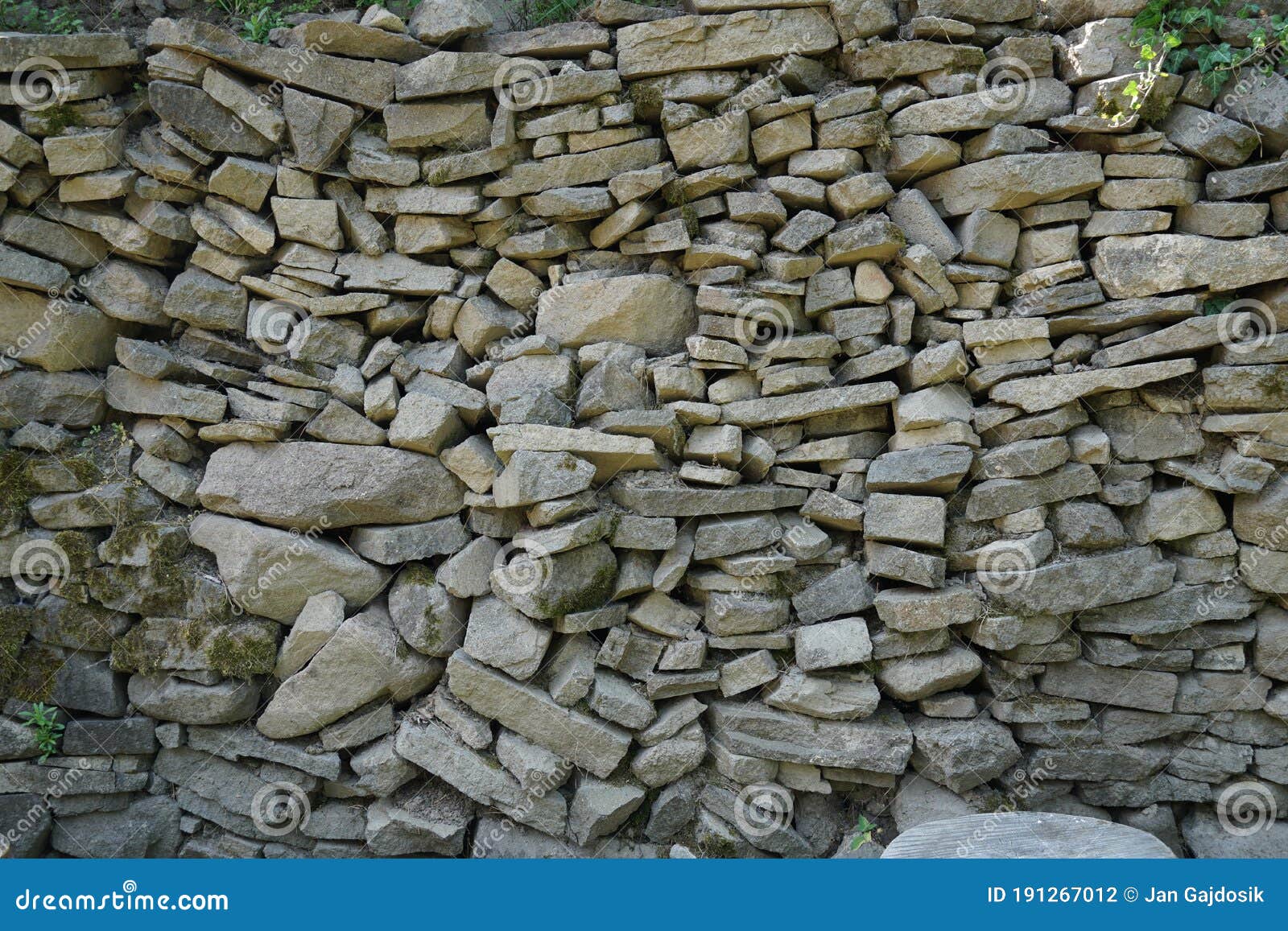 A Wall Consisting of Layered Flat Stones Creating a Structure Suitable ...