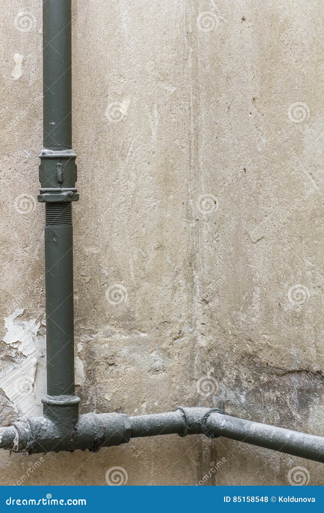 On the Wall in a Corner is an Old Heating Pipes, without a Radiator ...