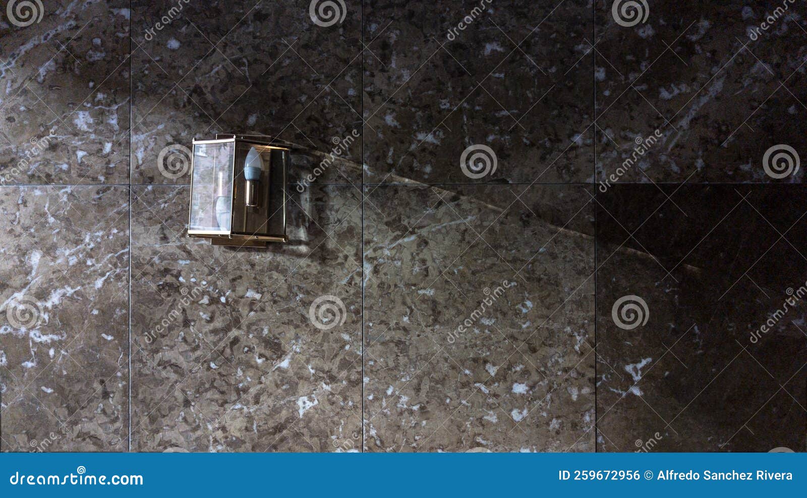 Wall Covered with Marble Tiles with a Muted Wall Light Stock Photo ...