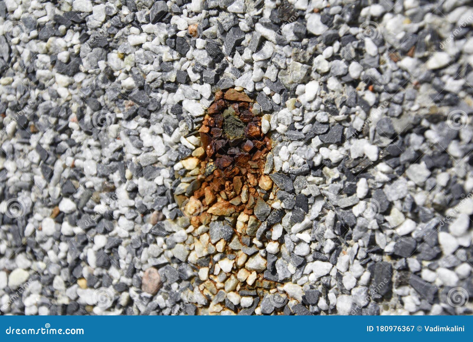 Wall Covered in Small Blue and White Rocks Bleeding Rust from a Hole ...